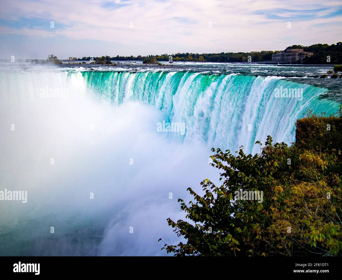 side view of a tall waterfall with fog below in summer Stock Photo - Alamy