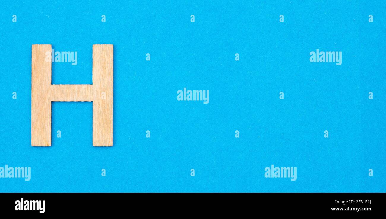 Letter H in white color on blue background Stock Photo - Alamy