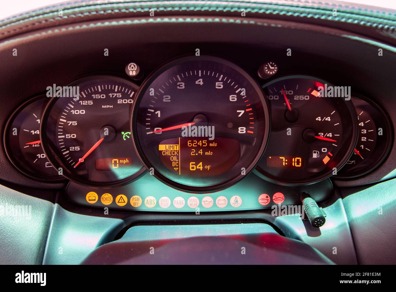 Sports car cockpit shows gauges with all warning lights illuminated on ...