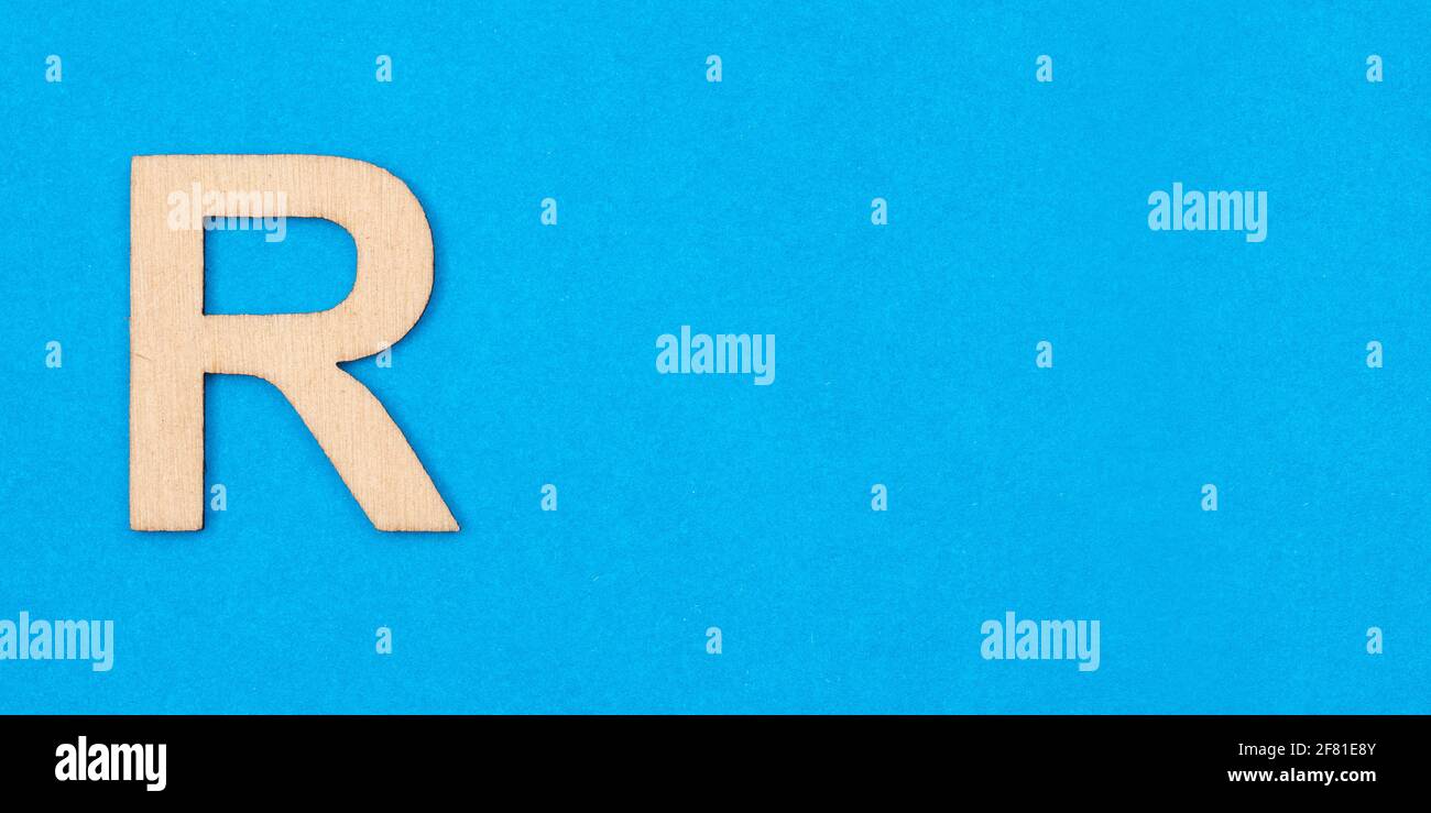 Letter R in white color on blue background Stock Photo - Alamy