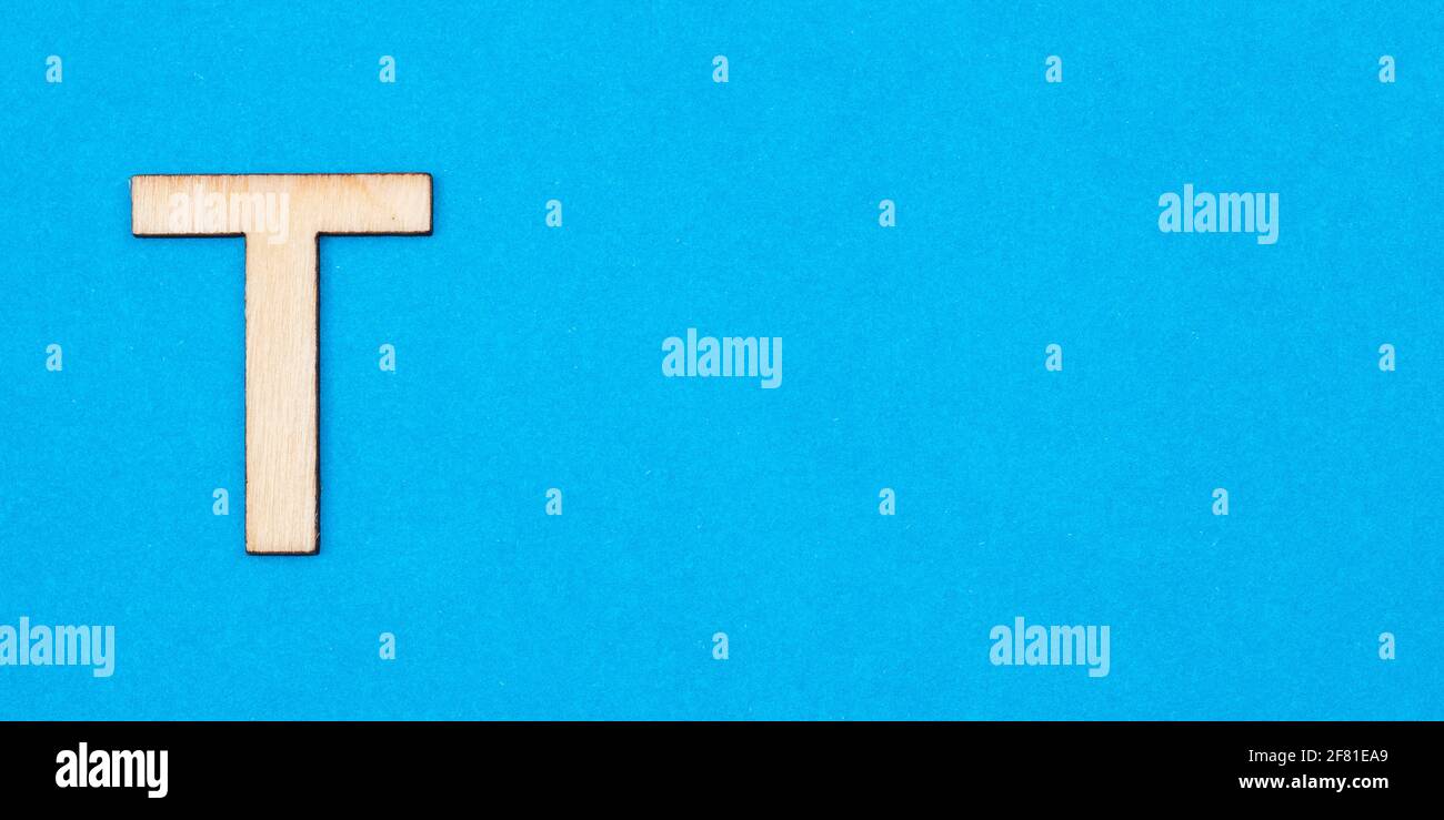 Letter T in white color on blue background Stock Photo - Alamy