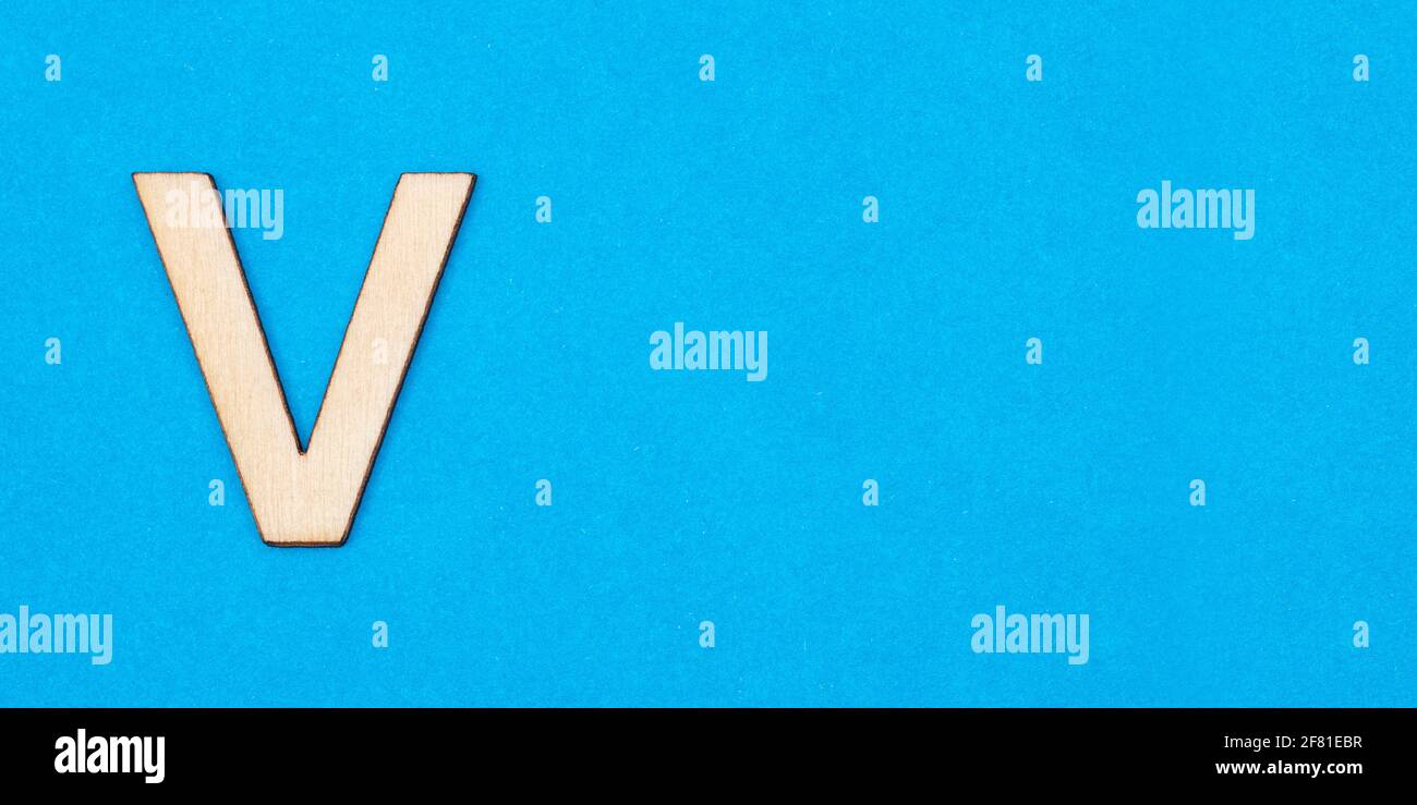 Letter V in white color on blue background Stock Photo - Alamy