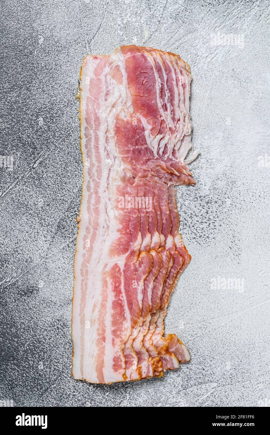 Smoked sliced pork bacon ready for cooking. White background. Top view ...