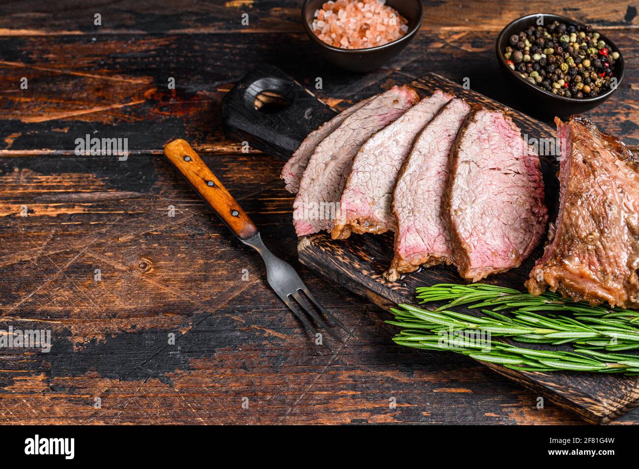 Sliced Roast beef sirloin tri tip steak bbq. Dark wooden background ...