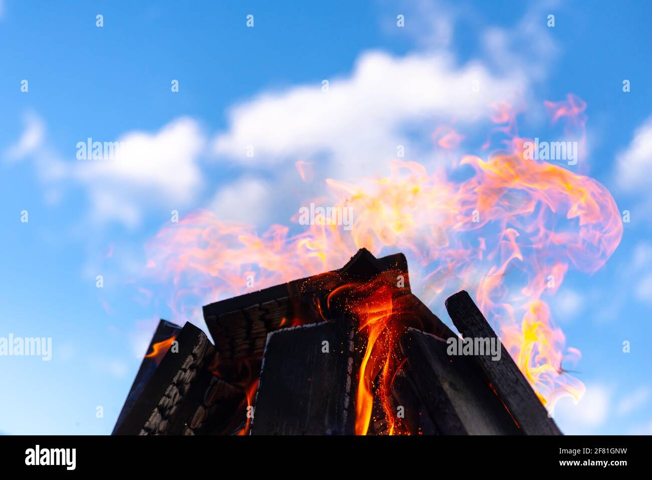 A large fire made of planks. Firewood in a bright flame. Bonfire ...