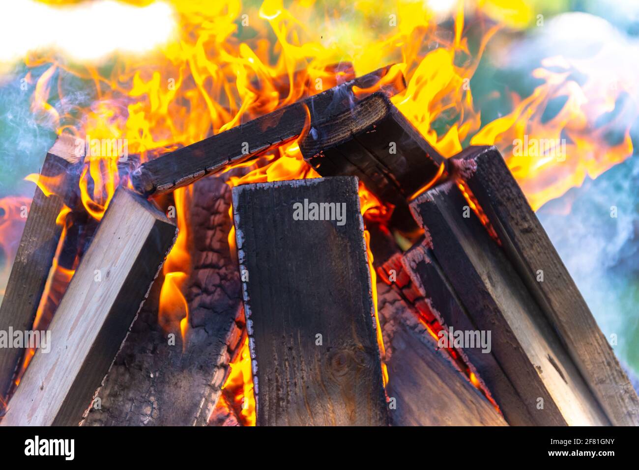A large fire made of planks. Firewood in a bright flame. Flames devour ...