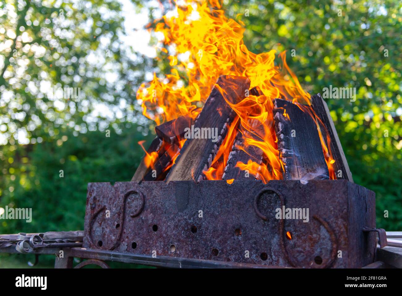 A large fire made of planks. Firewood in a bright flame. Firewood burns ...