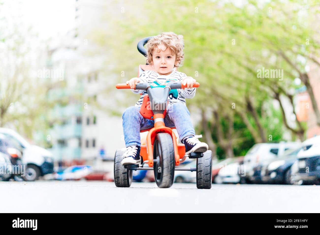Happy cute girl riding tricycle hi-res stock photography and images - Alamy