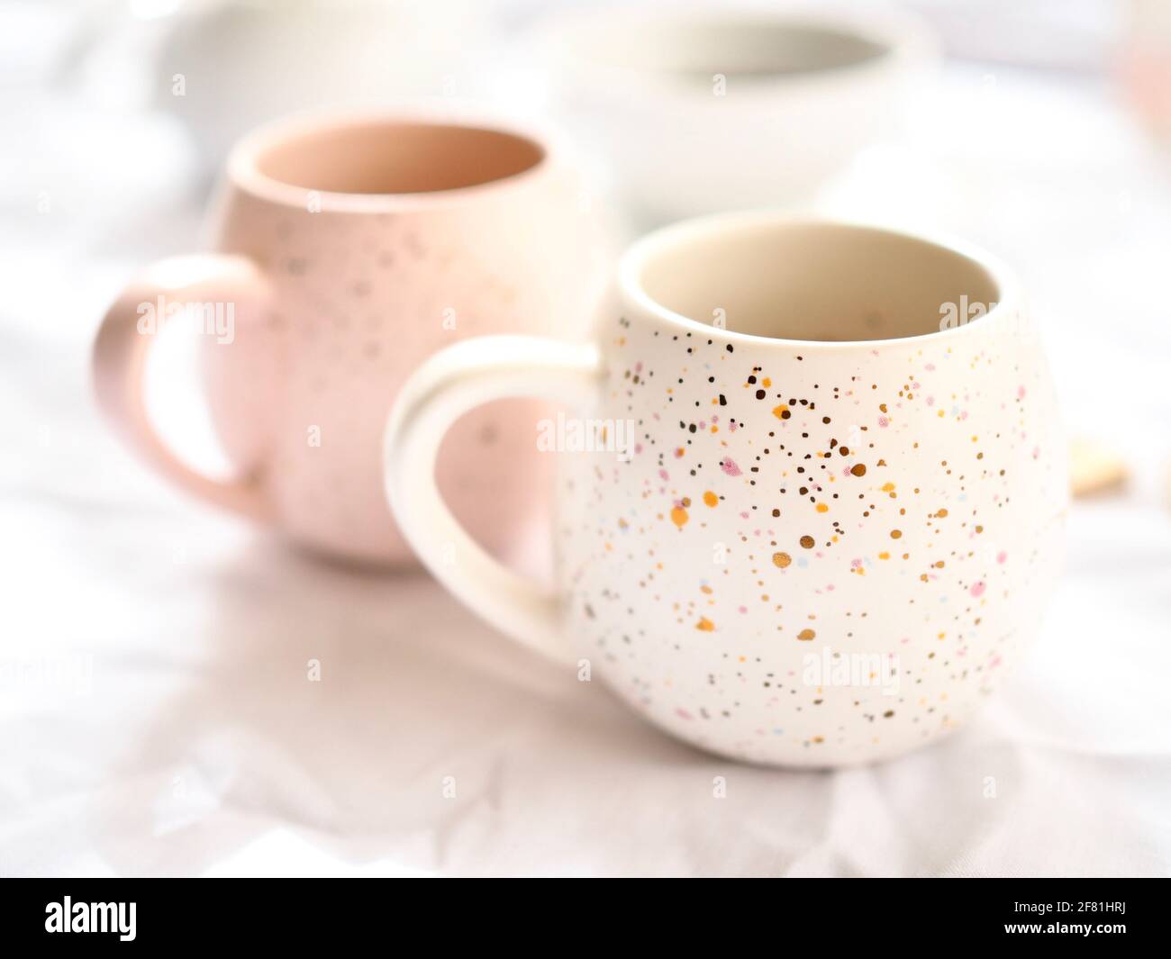 White and pink mug on a bright white textured background Stock Photo ...