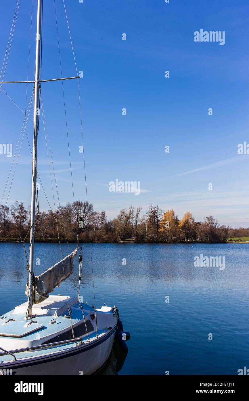 A small tourist ship on the blue lake Stock Photo - Alamy