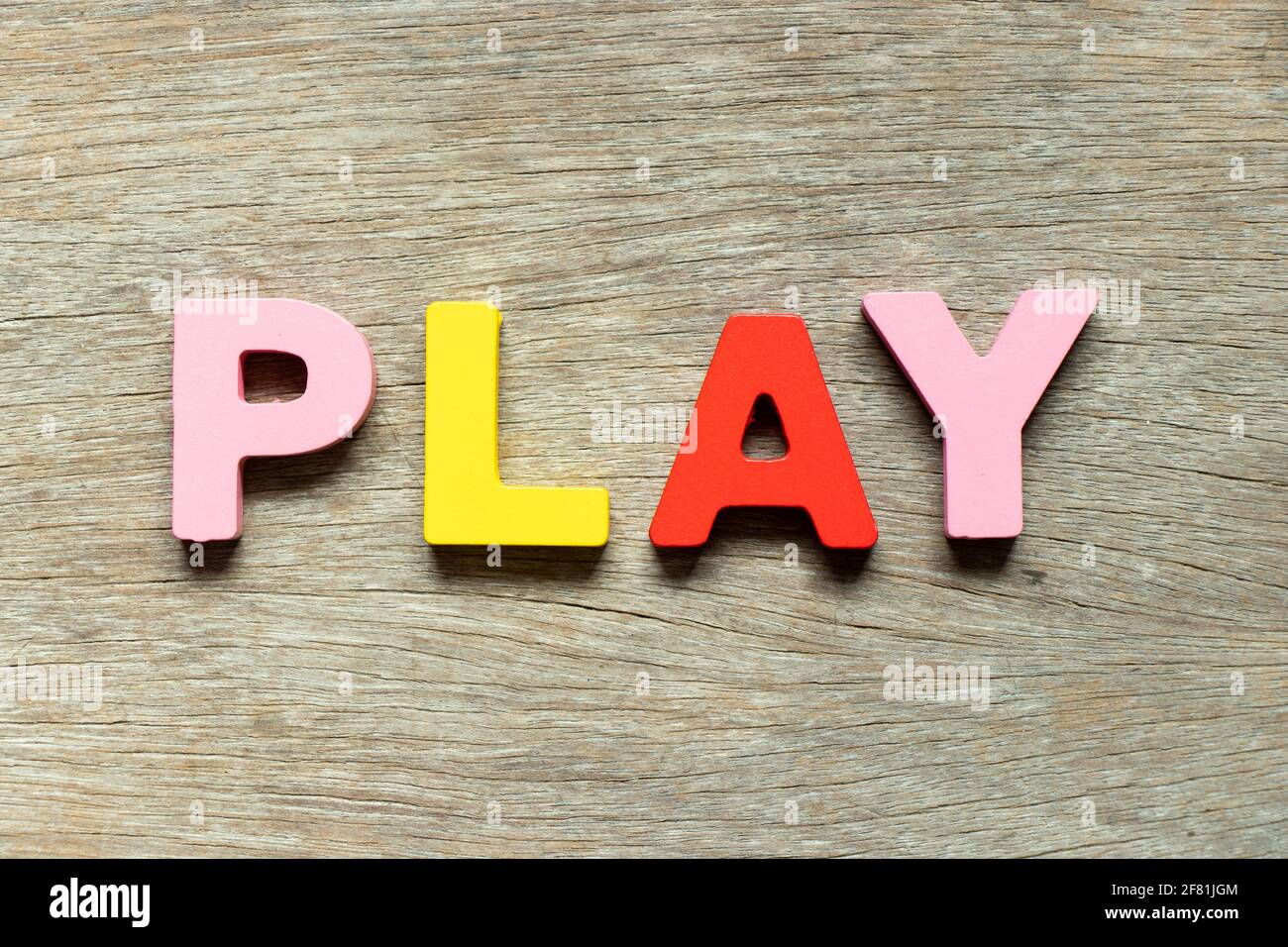 Color alphabet letter in word play on wood background Stock Photo - Alamy