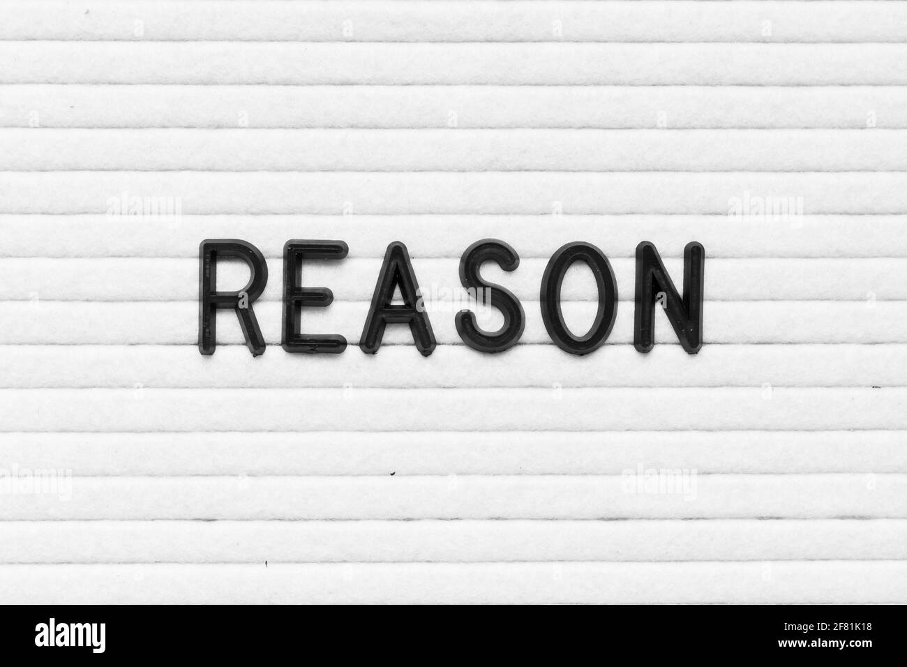 Black color letter in word reason on white felt board background Stock ...