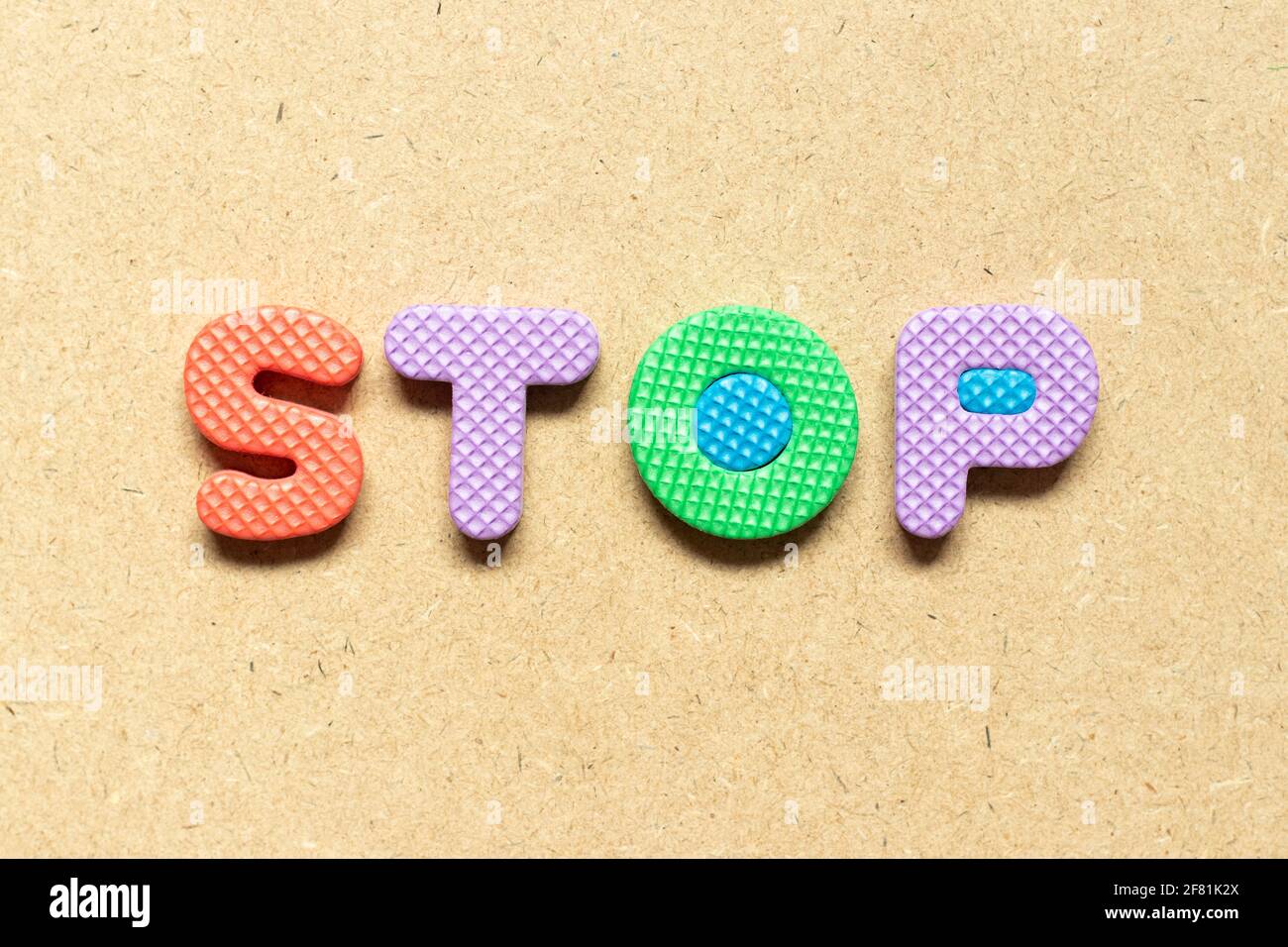 Foam alphabet letter in word stop on wood background Stock Photo - Alamy