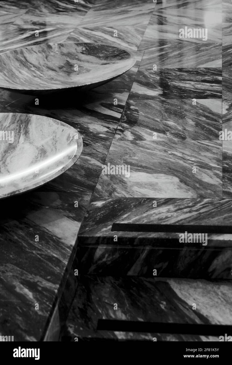 A vertical greyscale shot of marble plates on a texture of the same ...