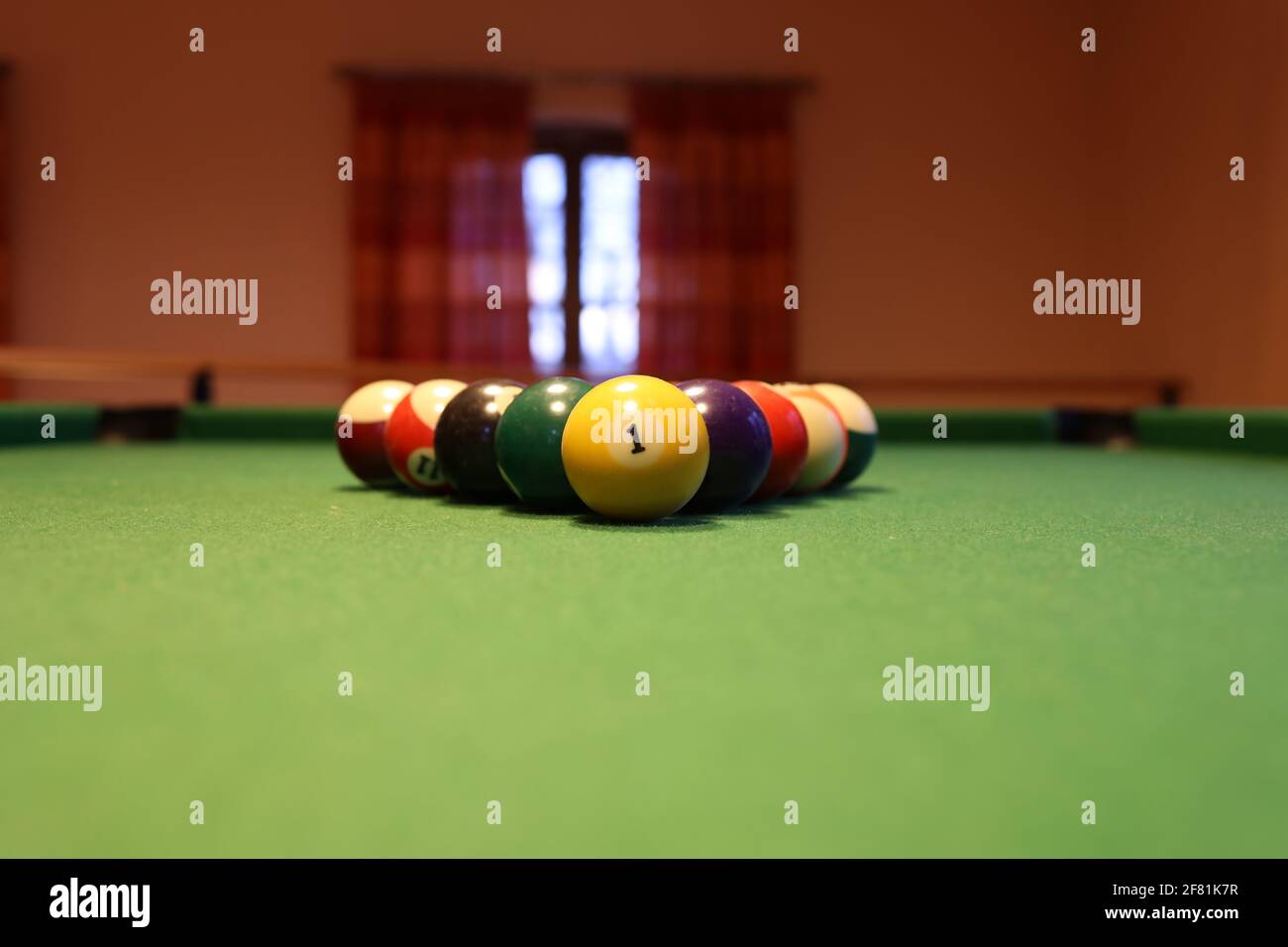 A green pool table with colored billiard balls Stock Photo - Alamy