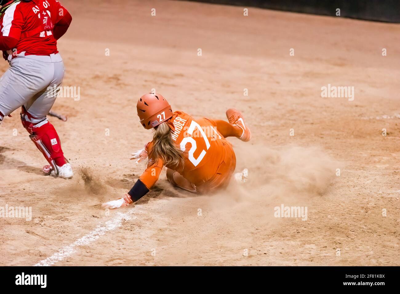 A Texas Longhorn Player is Sliding Into Home Plate Scoring A Run Stock ...