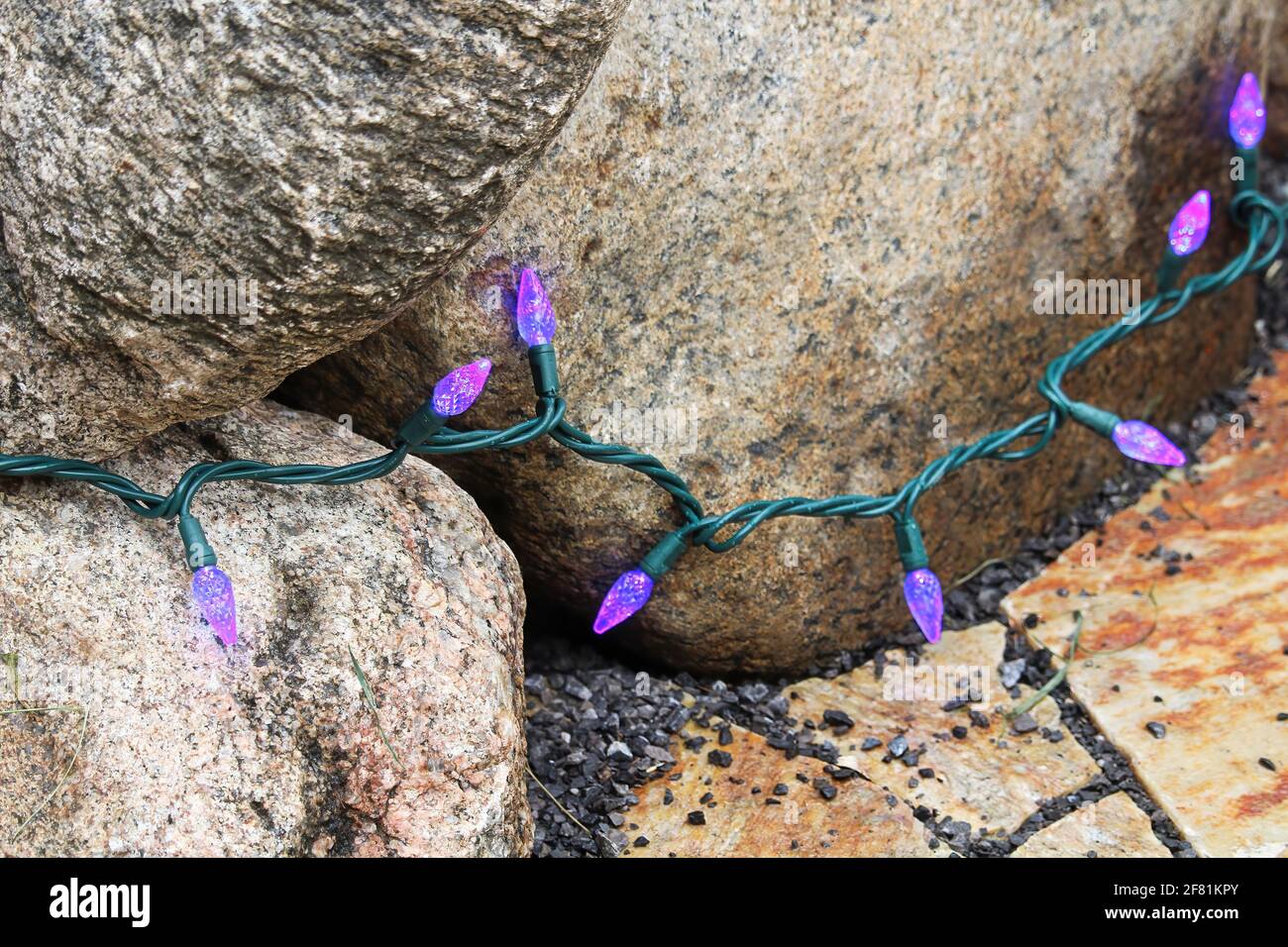 Landscaping lights placed between bolder and rocks Stock Photo - Alamy