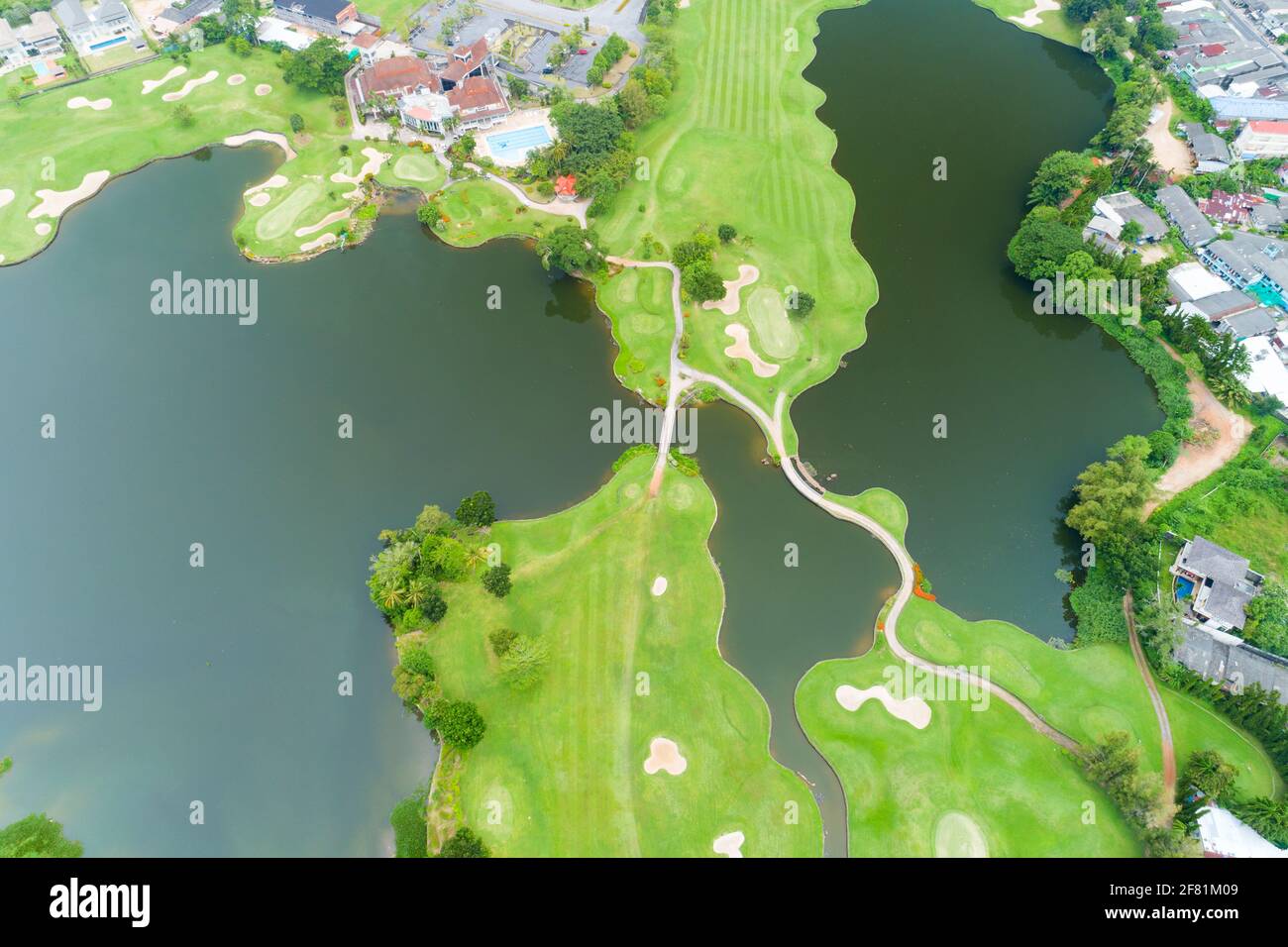 Aerial view drone shot of beautiful green golf field fairway and ...