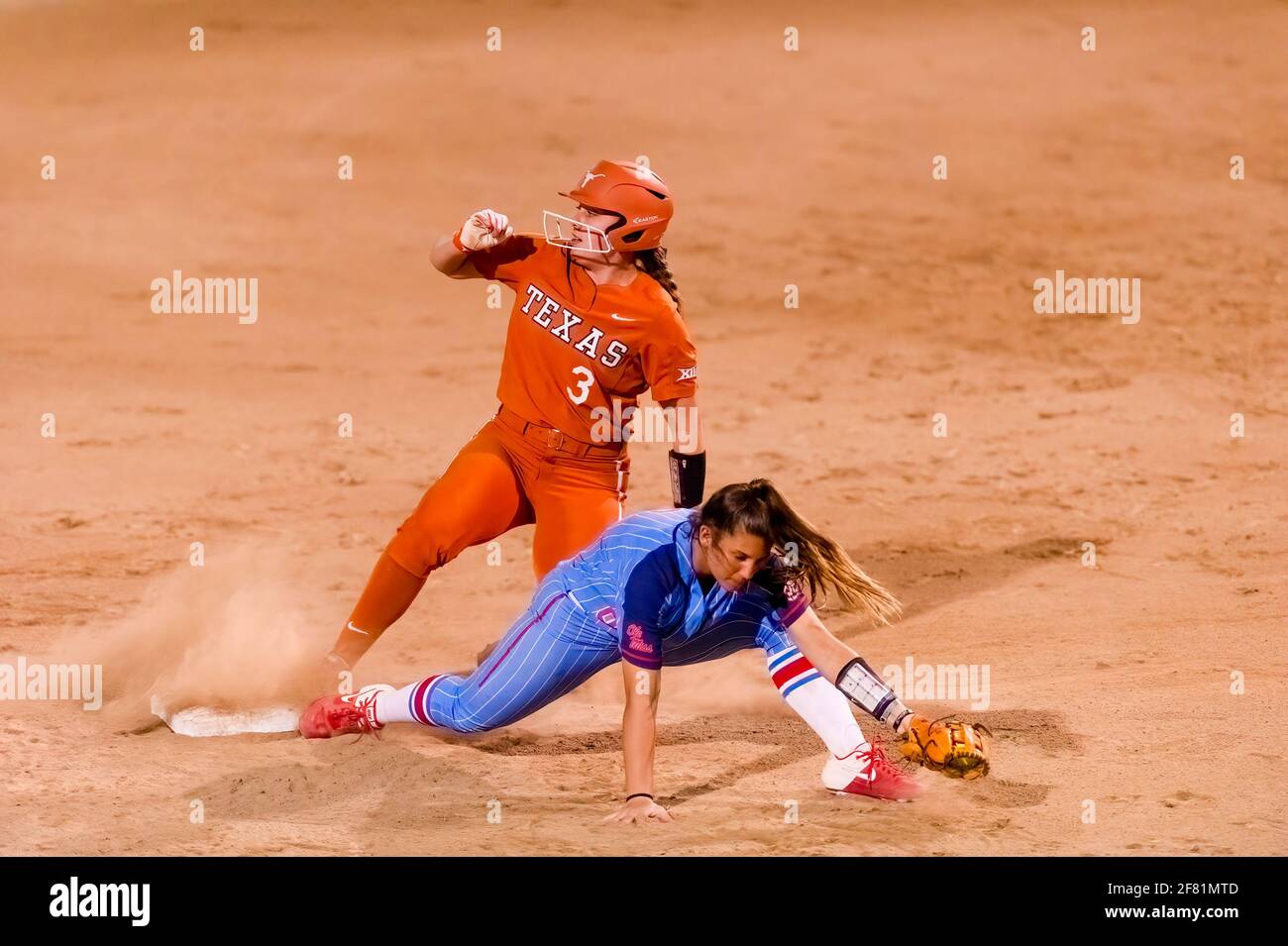 A Texas Longhorn Player Is Attempting A Stolen Base Against The Ole ...