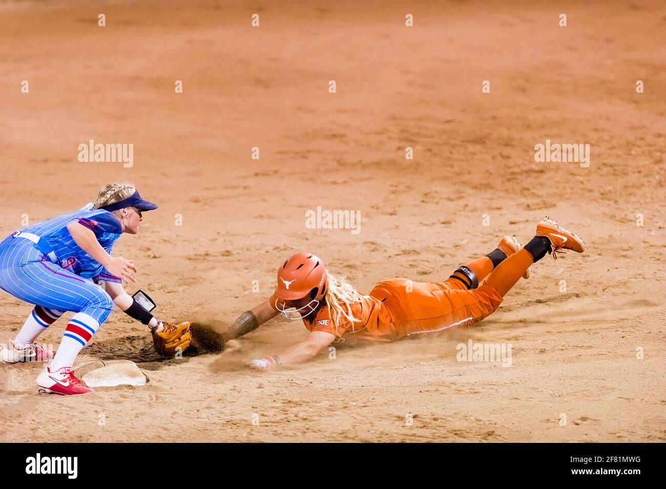 Girl softball player sliding into base hi-res stock photography and ...