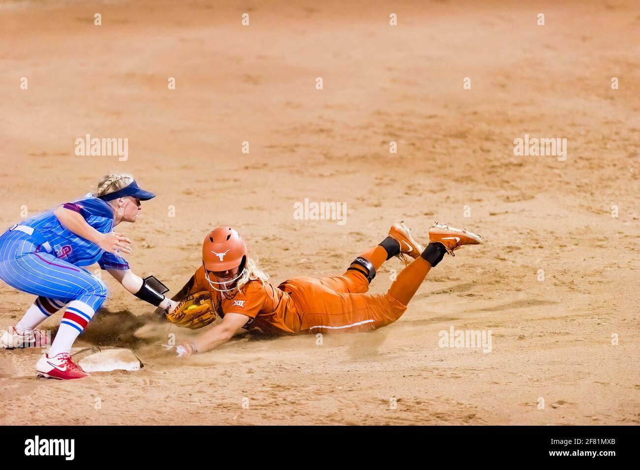 Girl softball player sliding into base hi-res stock photography and ...