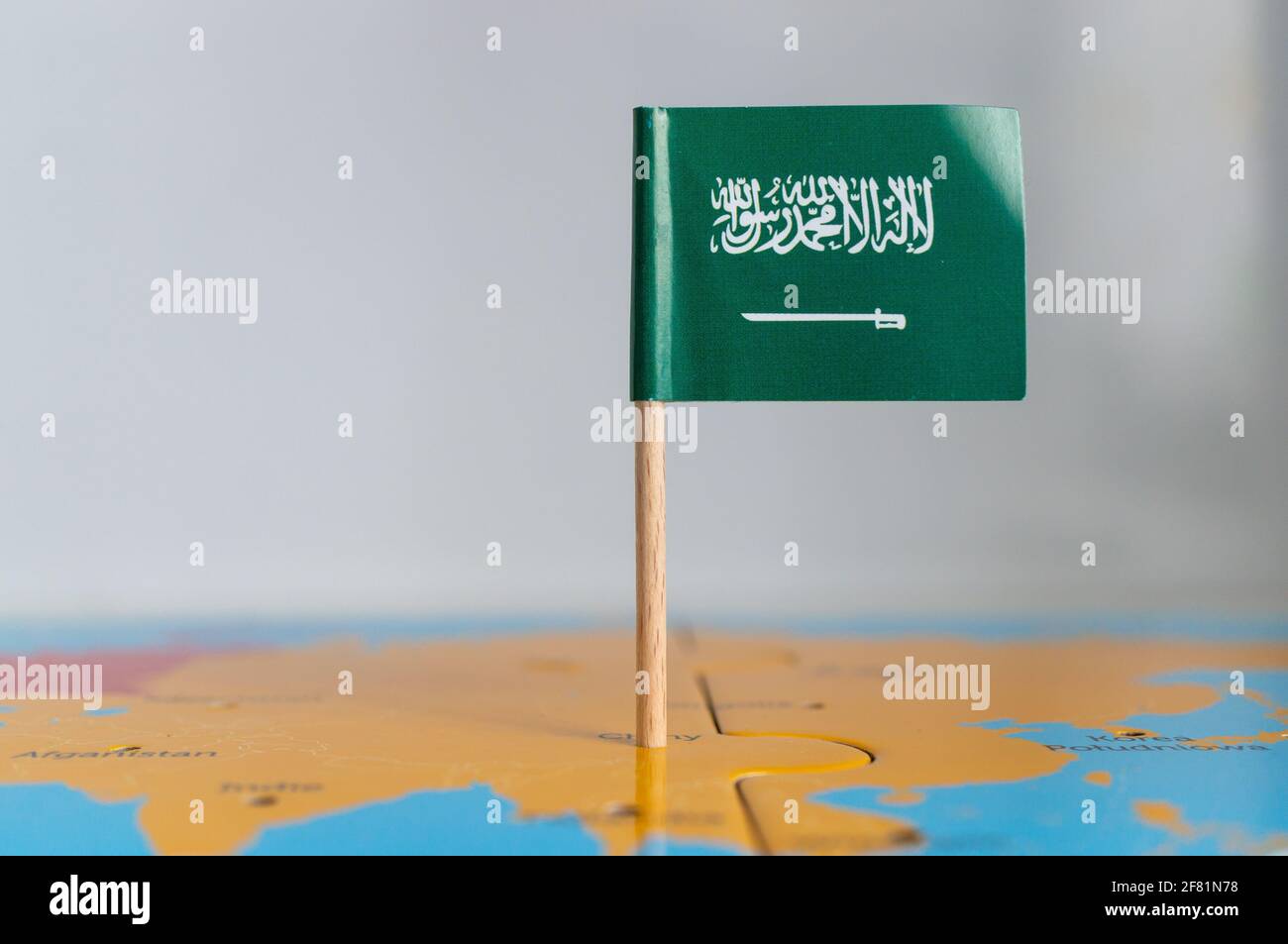 A small flag of Saudi Arabia on a wooden stick fixed on the globe Stock ...