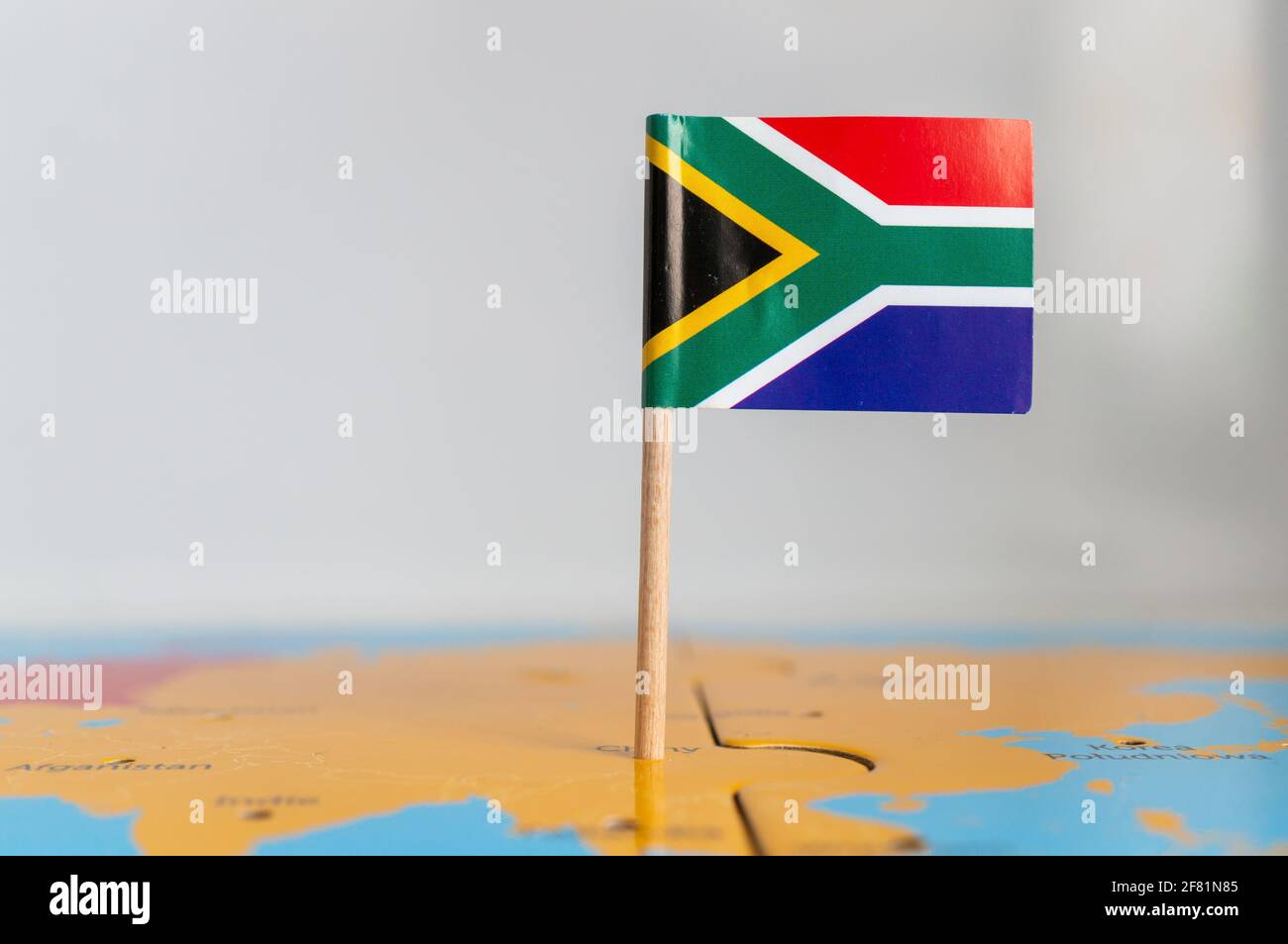 A small flag of South Africa on a wooden stick fixed on the globe Stock ...