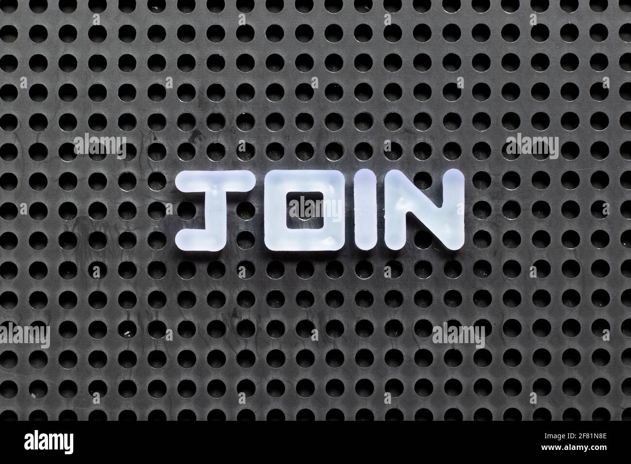 White color letter in word join on black pegboard background Stock ...