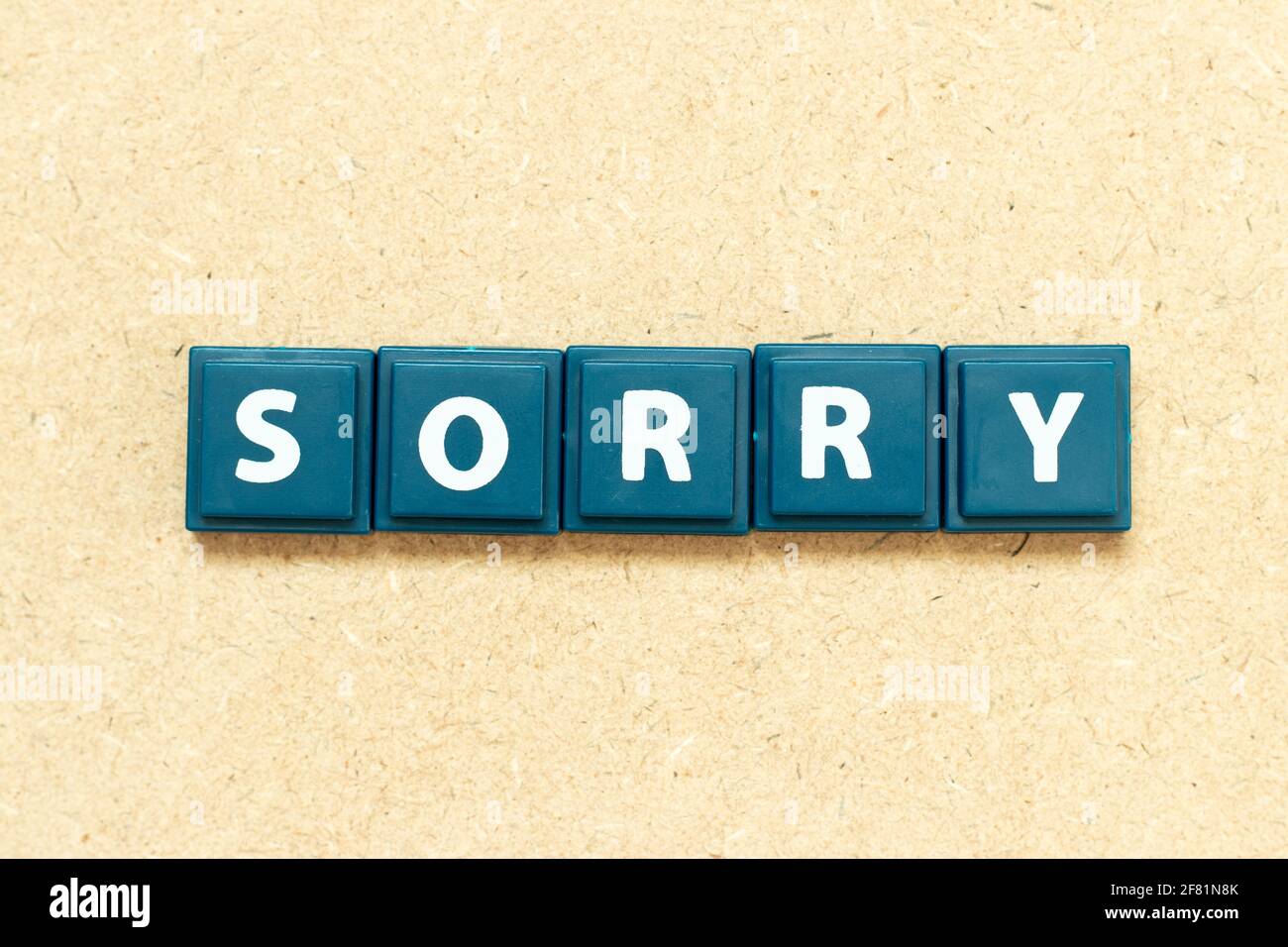 Tile alphabet letter in word sorry on wood background Stock Photo - Alamy