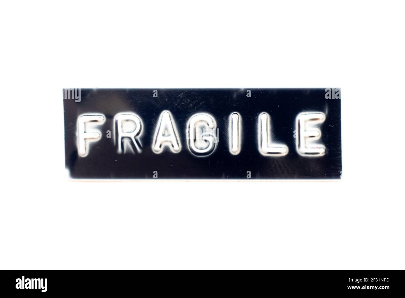 Embossed letter in word fragile on black banner with white background ...
