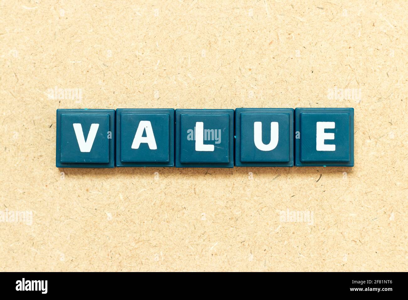 Tile alphabet letter in word value on wood background Stock Photo - Alamy