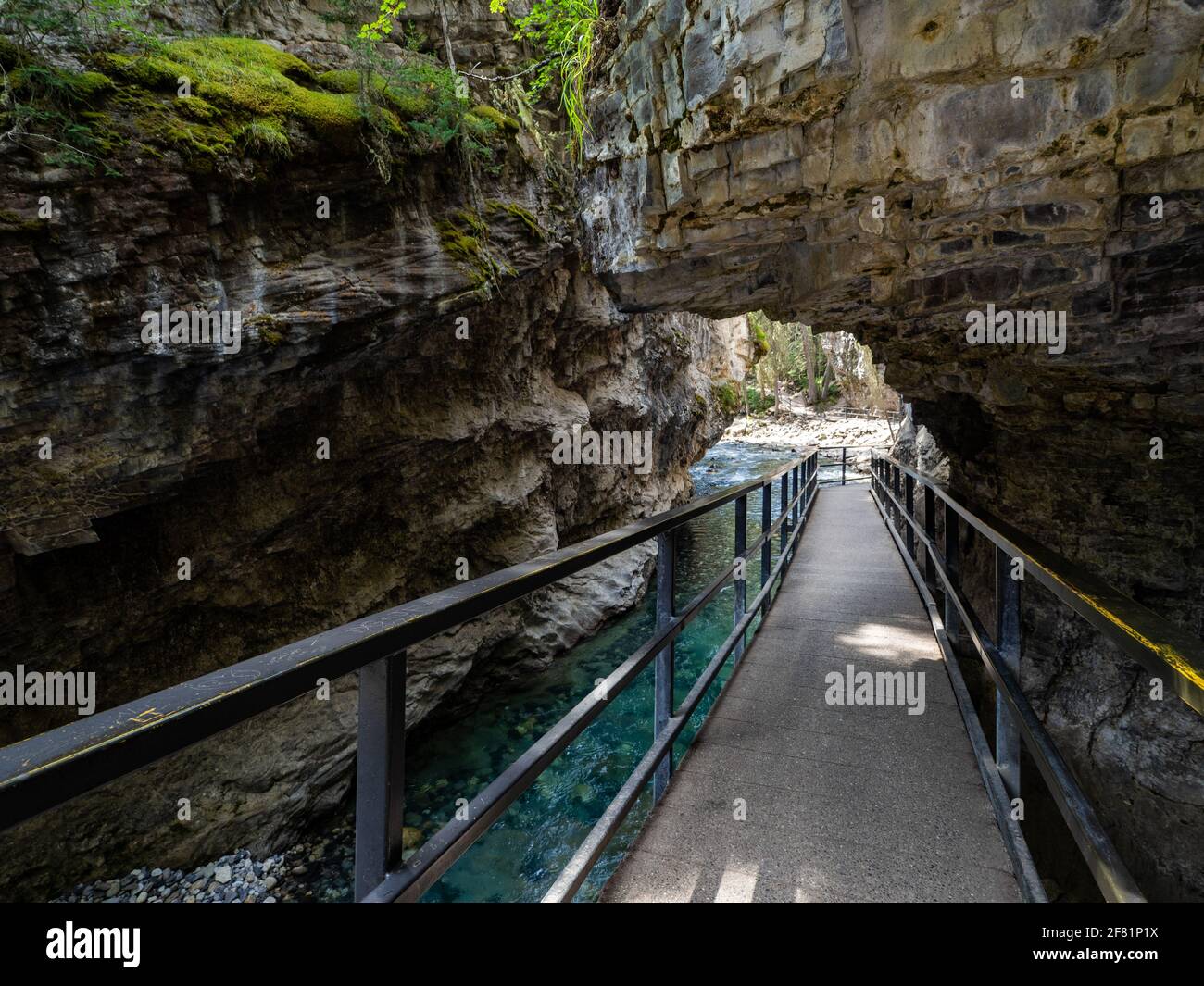 Pedestrian path in the middle of a canyon with a river Stock Photo - Alamy