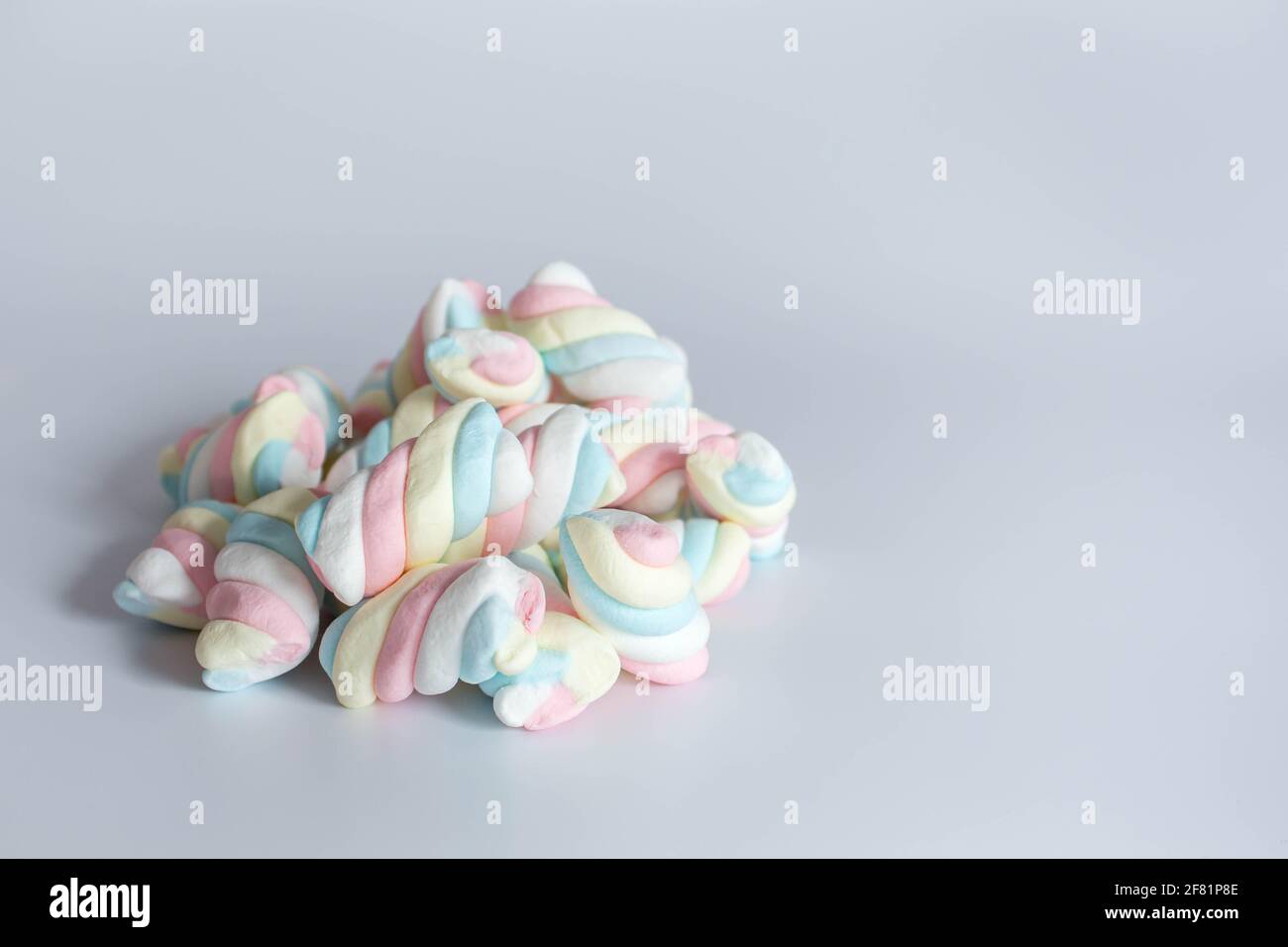 Colored twisted marshmallow on white Stock Photo - Alamy