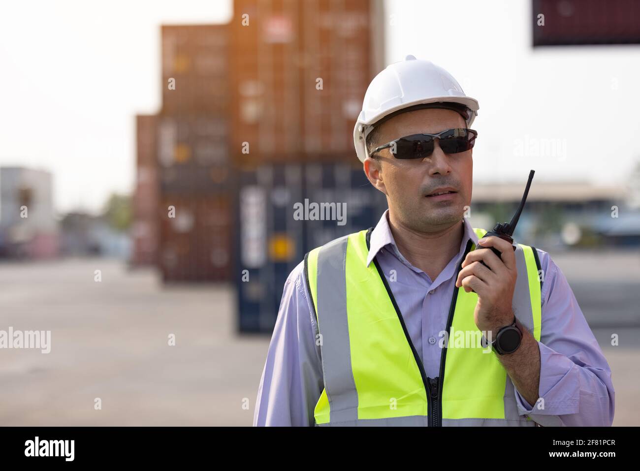 Foreman control loading Containers box from Cargo freight ship for ...