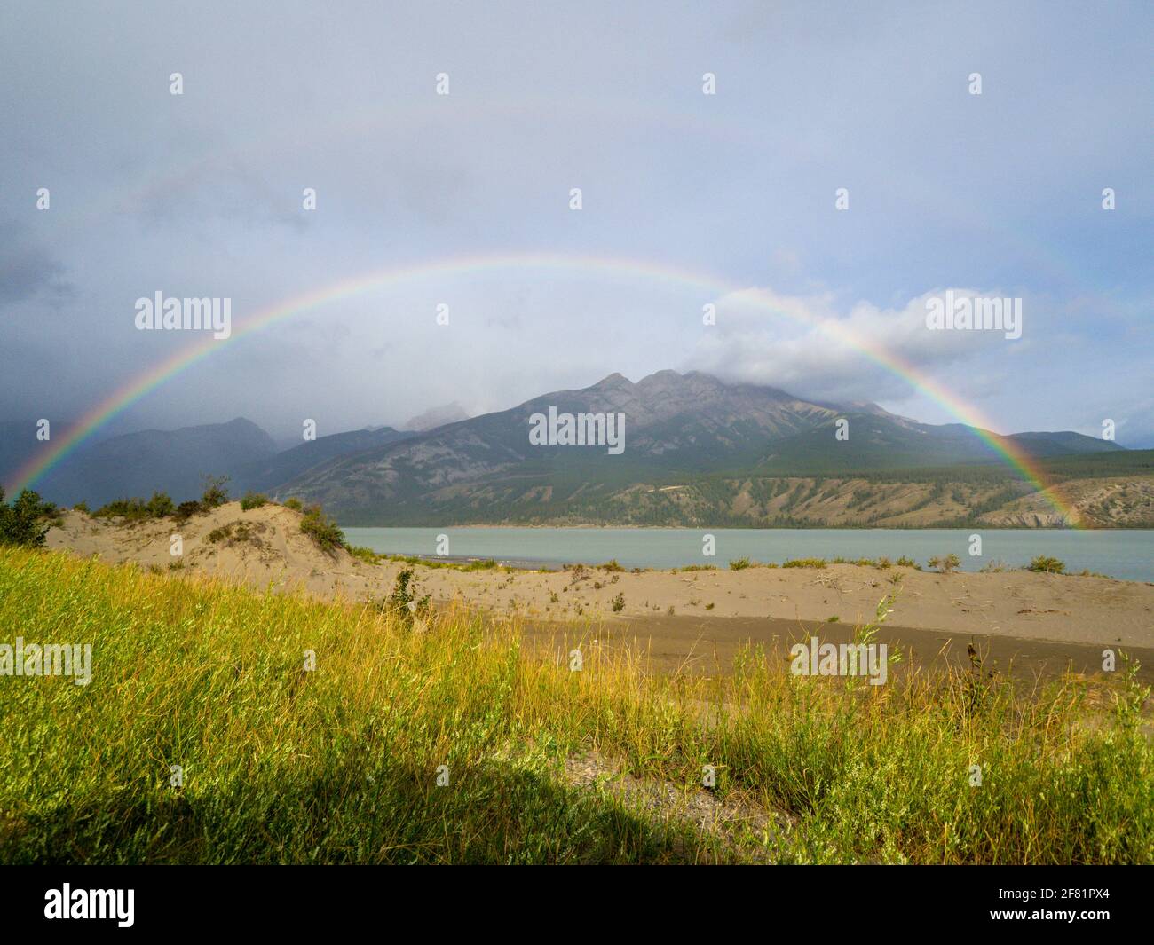 full rainbow on top of a lake in the mountains Stock Photo - Alamy