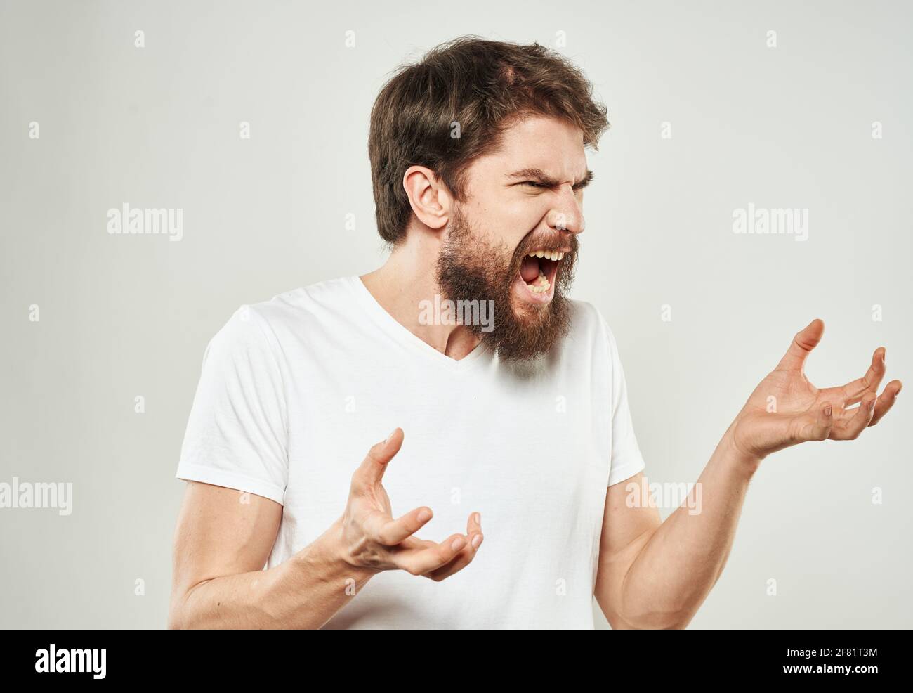 Aggressive man gestures with his hands thick beard irritability stress ...