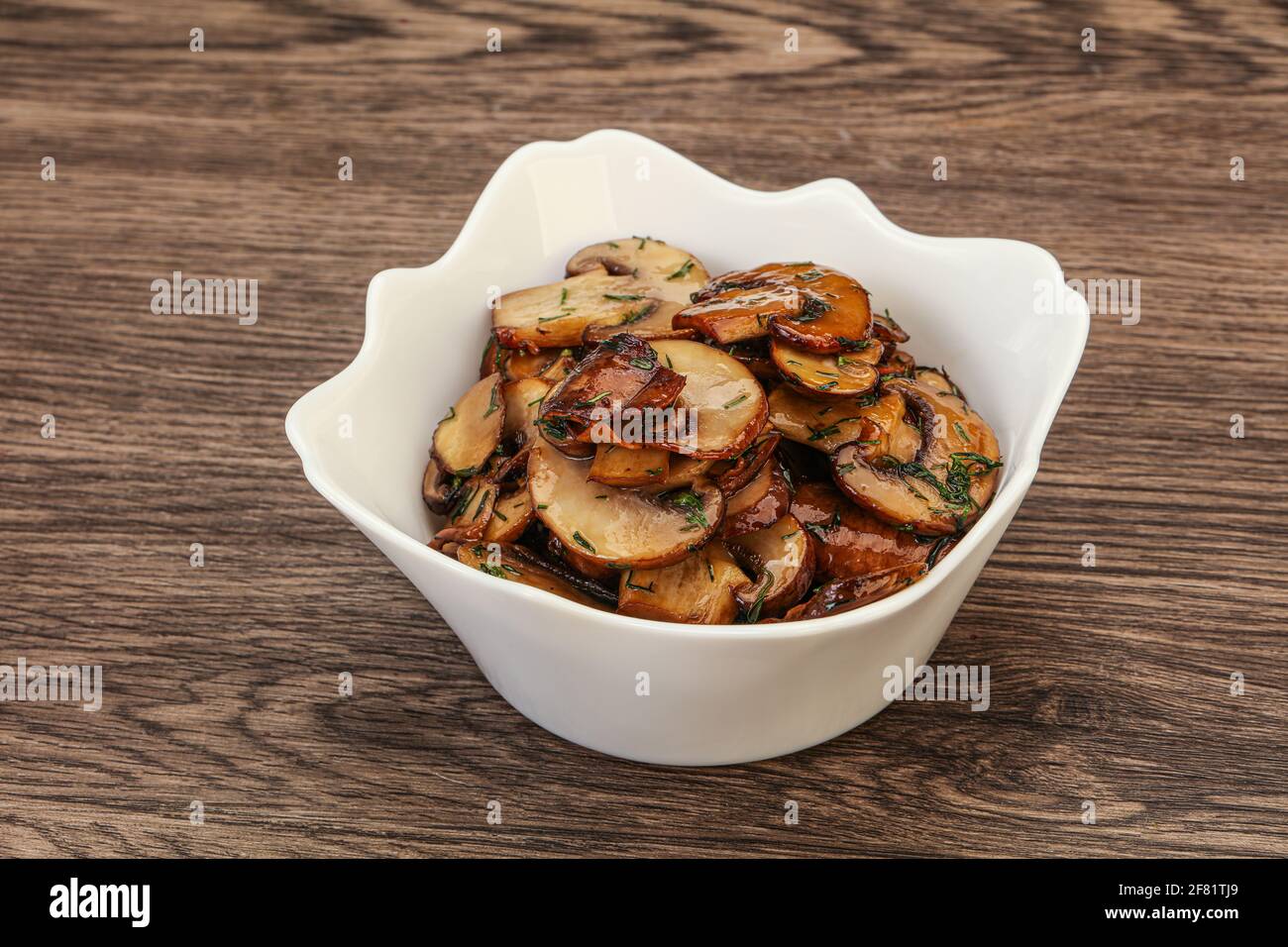 Roasted champignon with herbs and spices in the bowl Stock Photo - Alamy