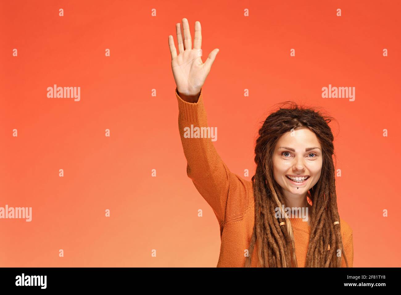 Young woman with authentic hairstyle and high five gesture Stock Photo ...