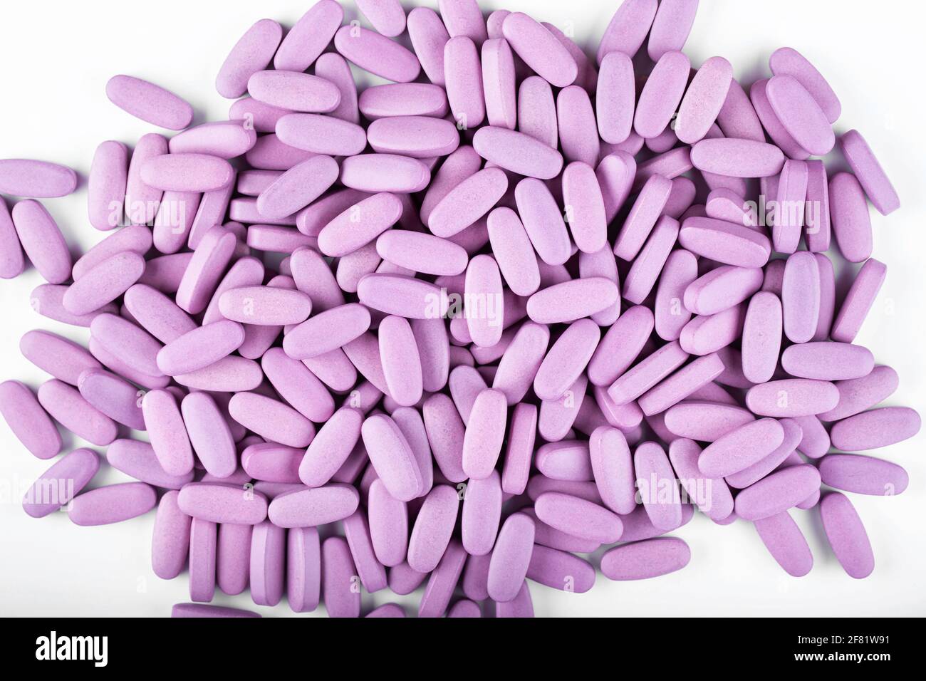Purple pills on a white background. Global health care concept ...