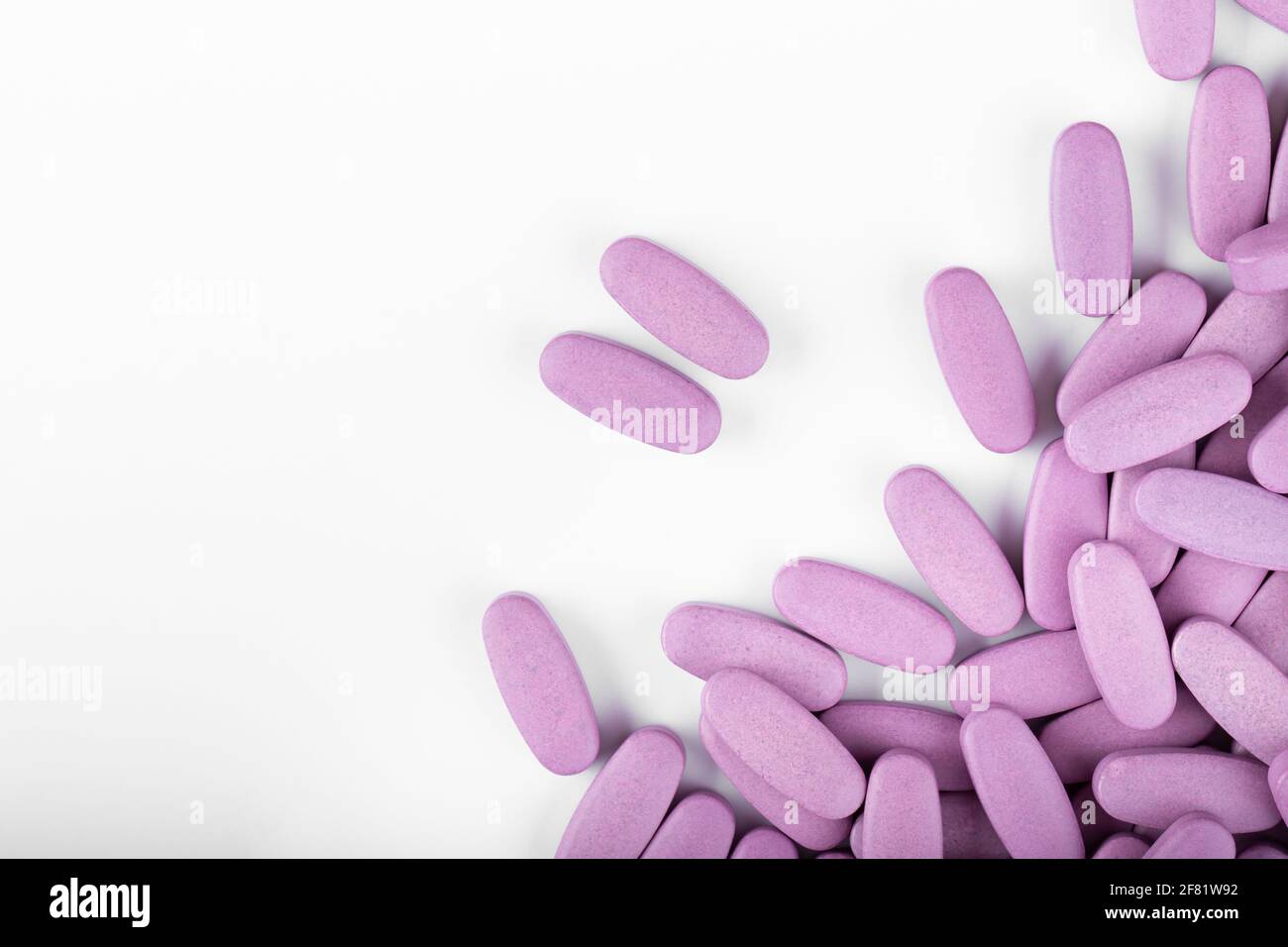 Purple pills on a white background. Global health care concept ...