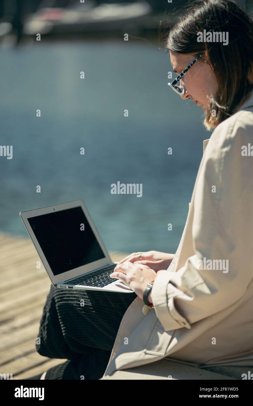 A portrait of a young french businesswoman with her laptop in Lyon ...