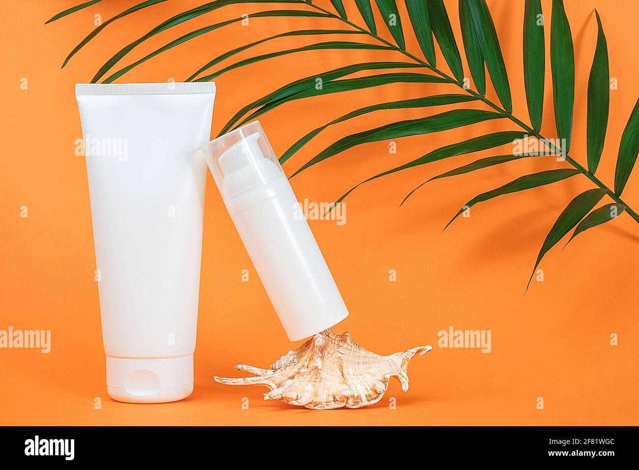 Two white blank cosmetics bottles with sunscreen, suncream or other ...