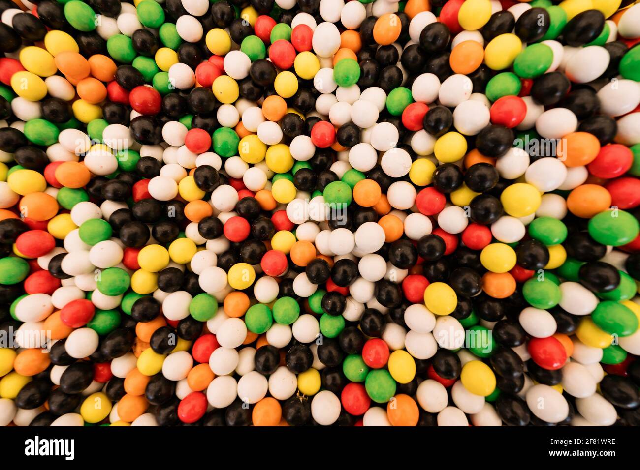 Texture of vibrant multi colored sweet spheric candies. Background made ...