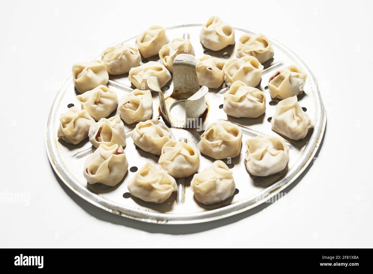 A top view of delicious homemade manti dumplings on a white surface ...