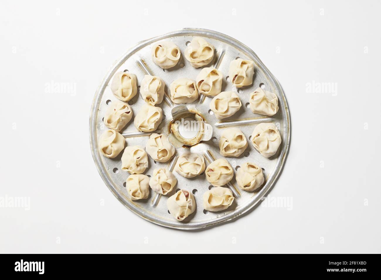 A top view of delicious homemade manti dumplings on a white surface ...