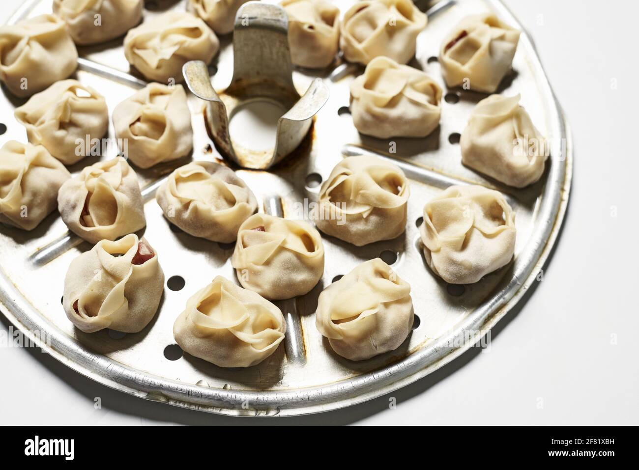 A top view of delicious homemade manti dumplings on a white surface ...