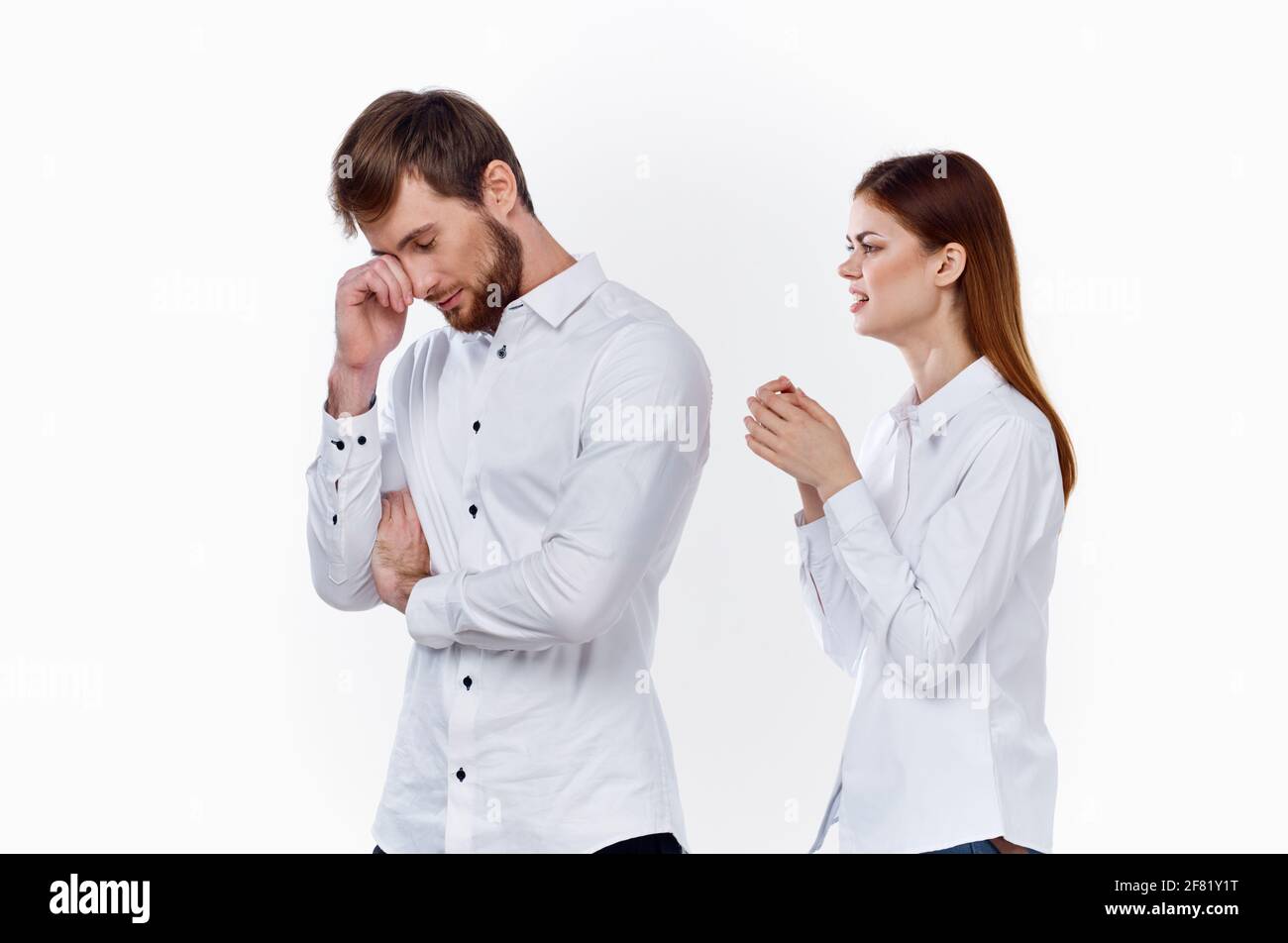 offended woman looks at from a returning man on a light background ...