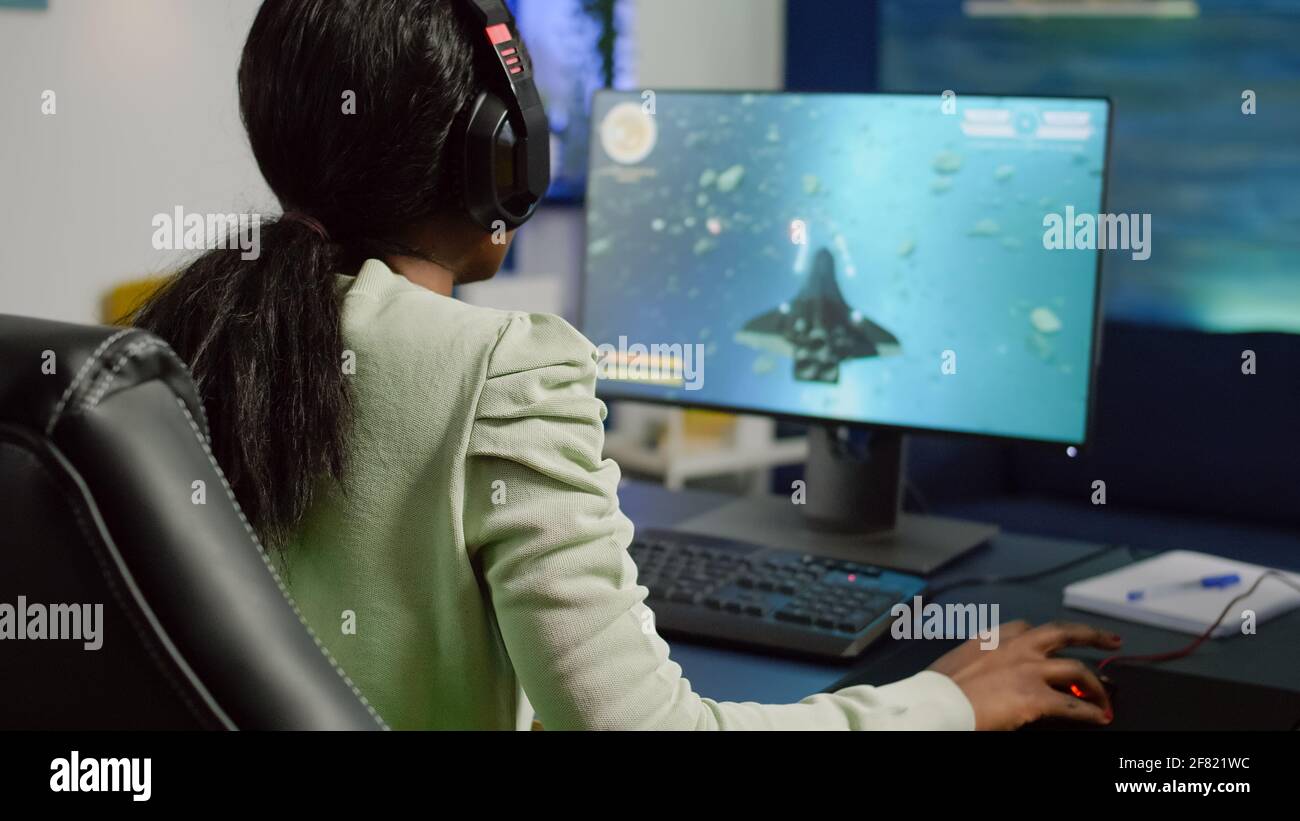 Excited african gamer with headphone winning important online esport ...