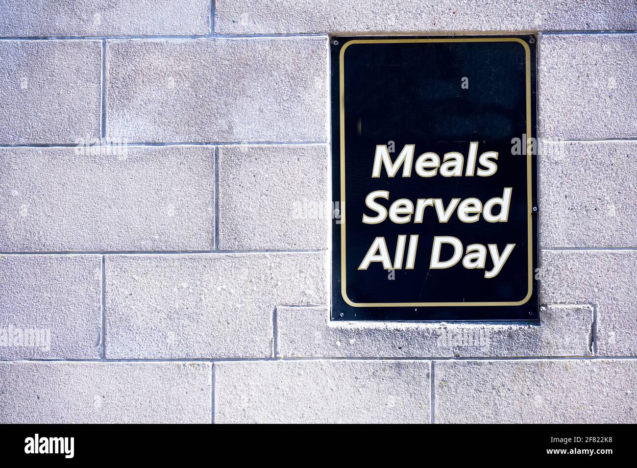 Meals served all day sign on wall of restaurant Stock Photo - Alamy
