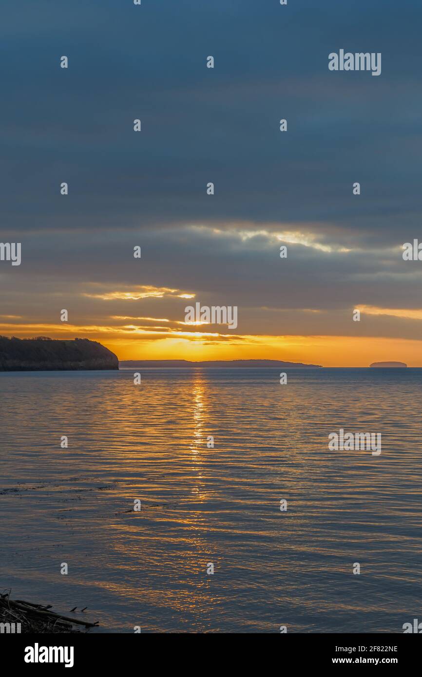 The sun setting over Sand Point Stock Photo - Alamy